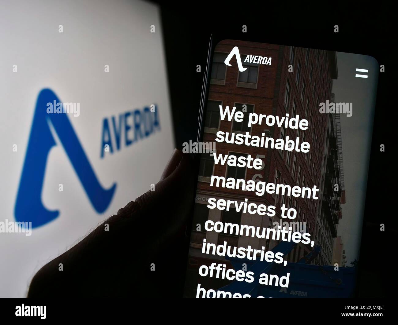 Stuttgart, Germany, 12-14-2022: Person holding smartphone with website of Emirati company Averda ...