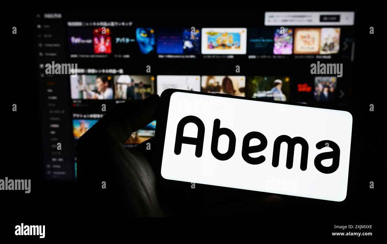Stuttgart, Germany, 12-23-2022: Person holding cellphone with logo of Japanese streaming company ...