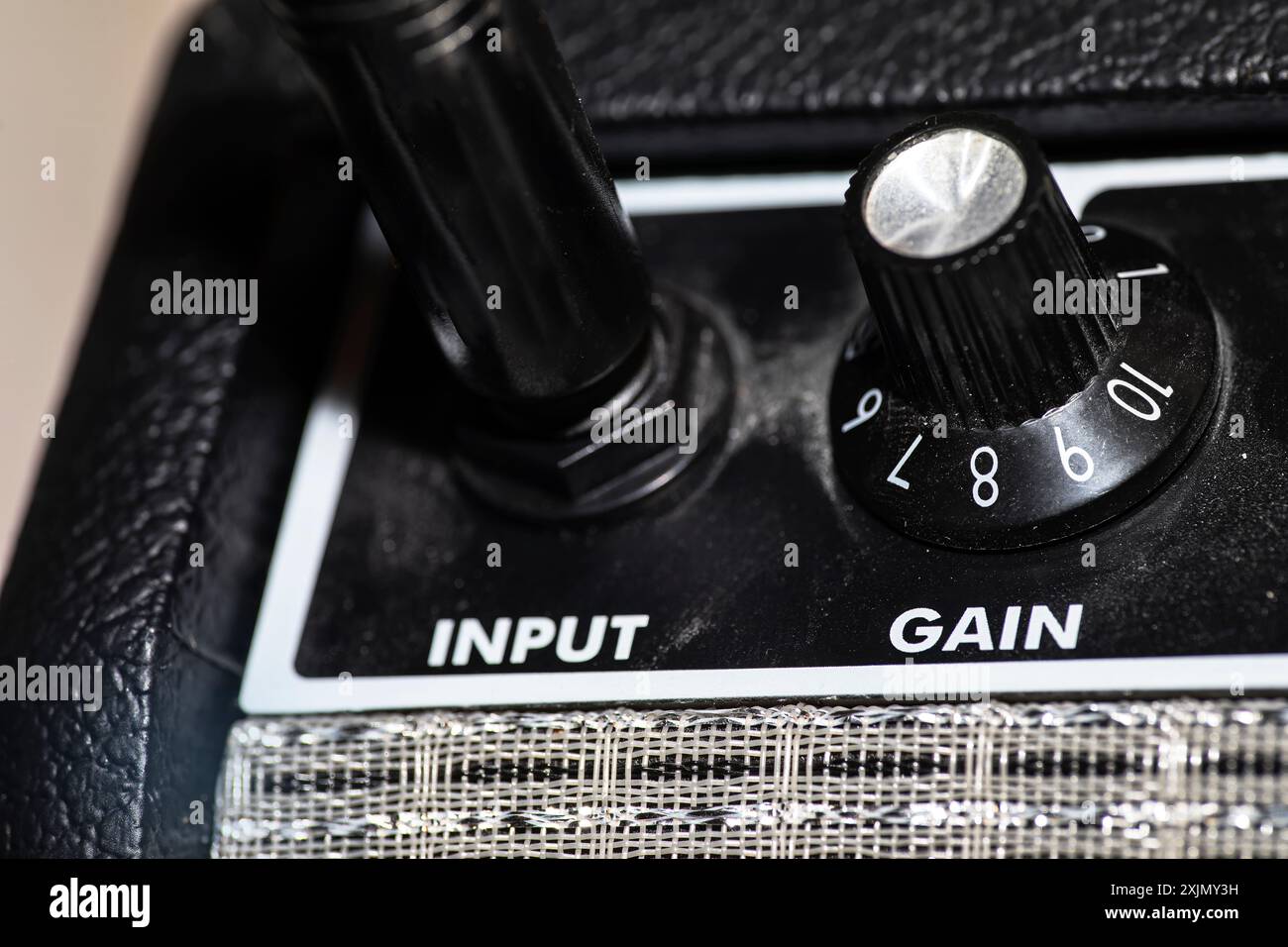 Black and white guitar amplifier with a knob labeled input and gain ...