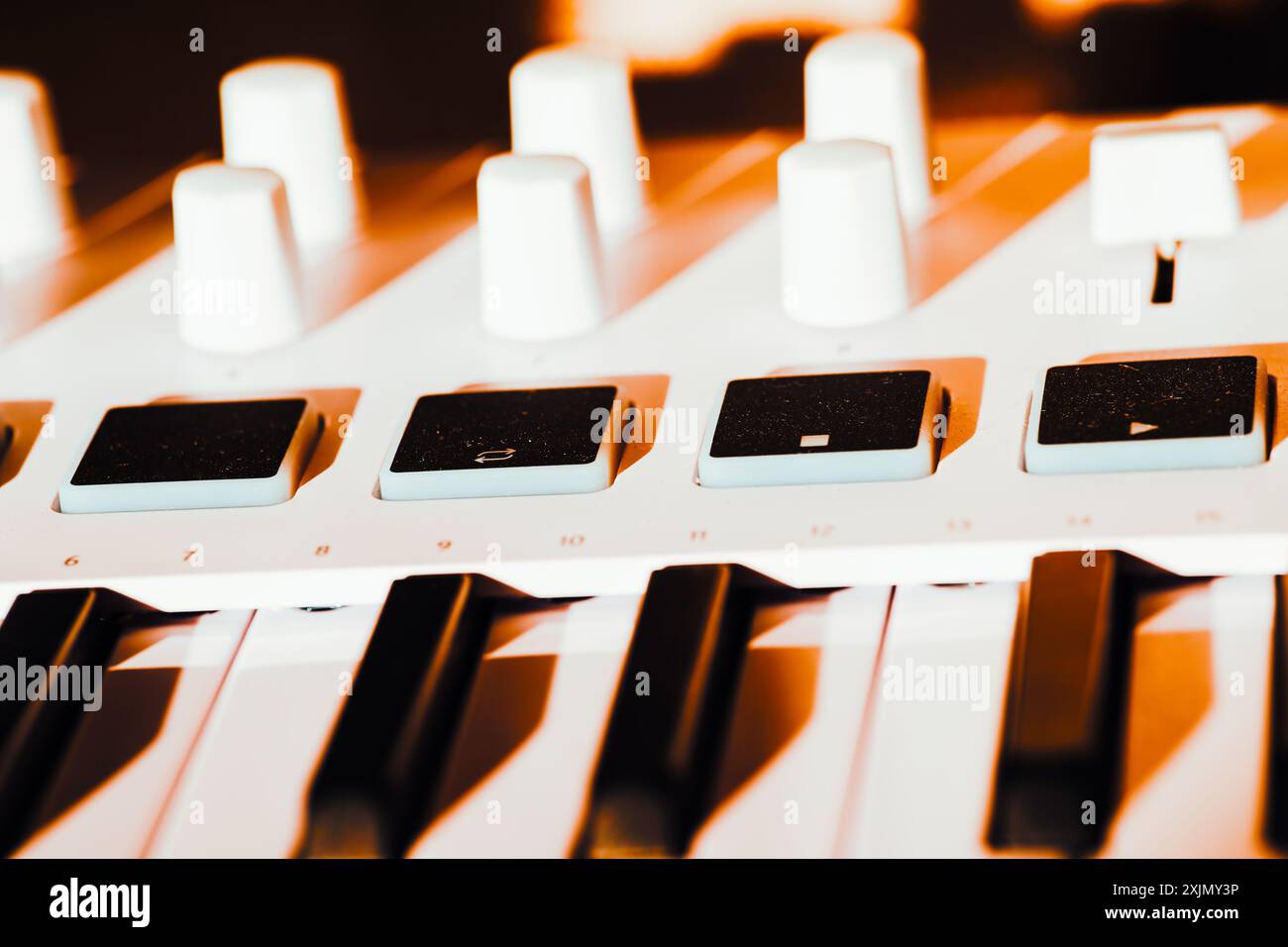 White keyboard with black keys. The keyboard is placed on a table ...