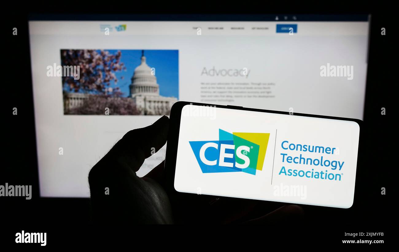 Stuttgart, Germany, 01-06-2023: Person holding mobile phone with logo of American Consumer ...