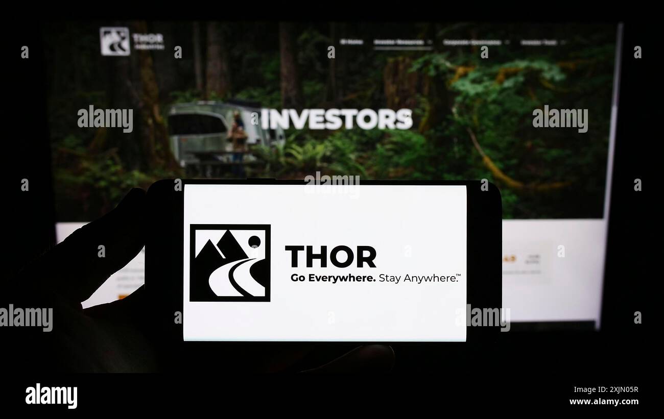 Stuttgart, Germany, 12-31-2022: Person holding mobile phone with logo ...