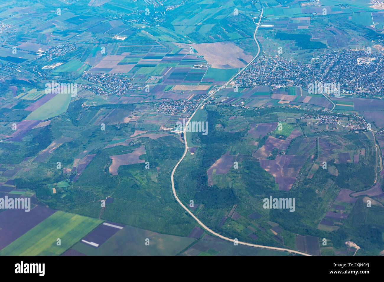 Aerial view of a rural area with a running road. Green Earth view from ...