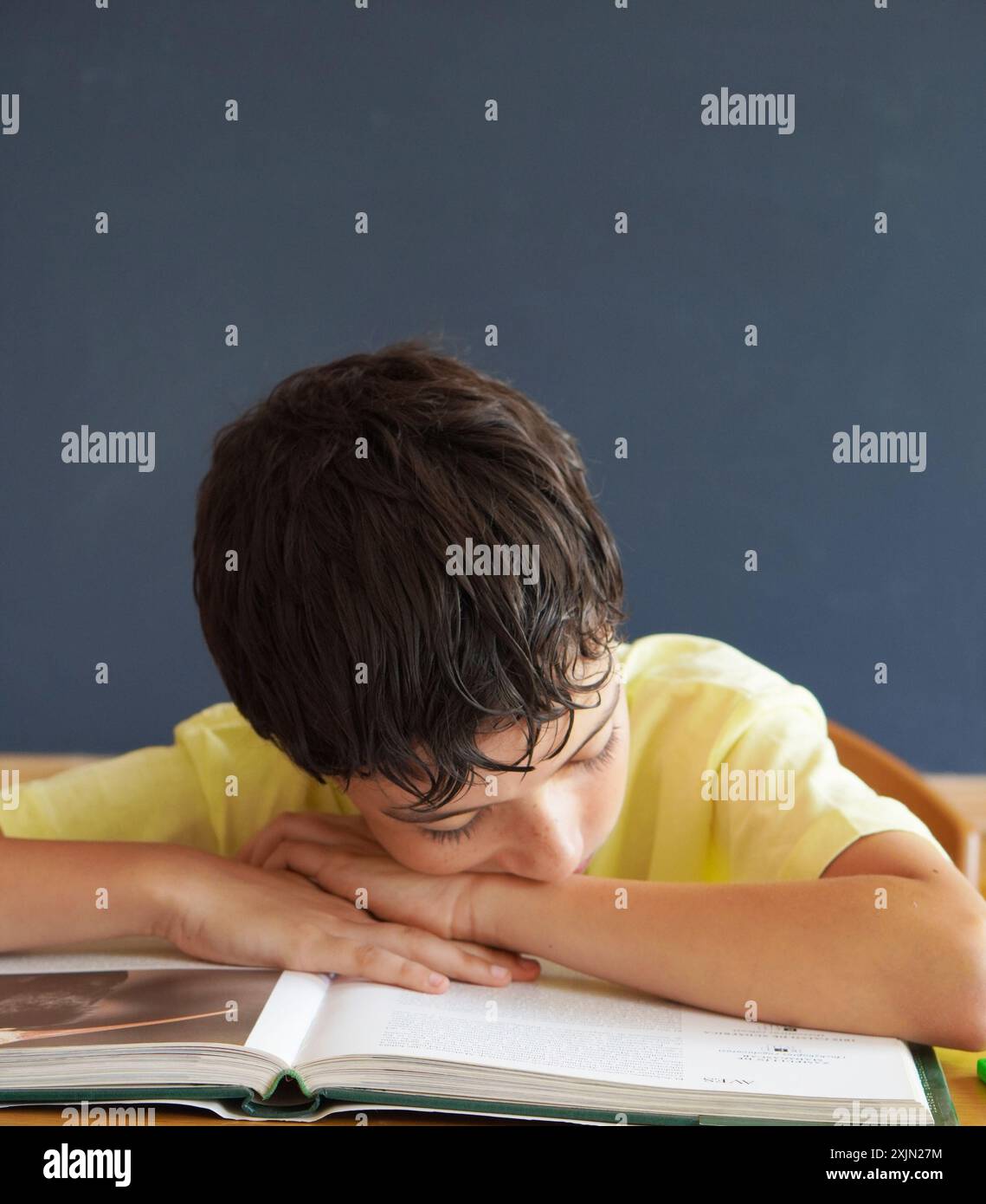 preteen boy, falling asleep, bored, studying a book Stock Photo - Alamy