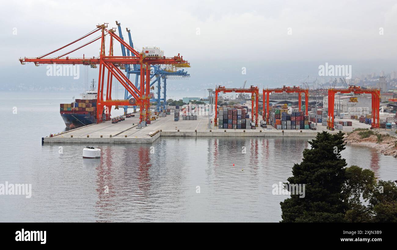 Container ship docked at port with gantry cranes loading containers hi ...