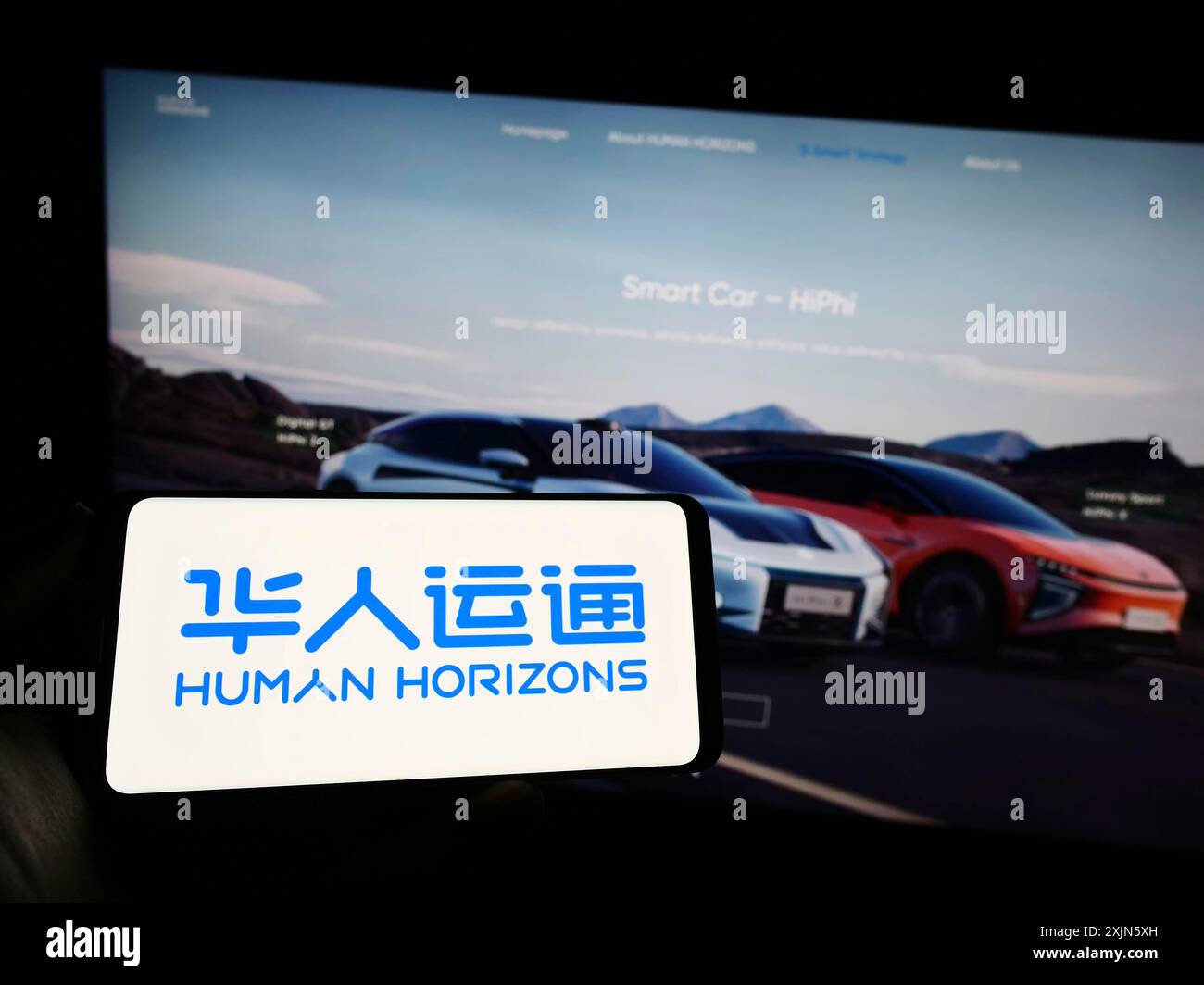 Stuttgart, Germany, 04-04-2023: Person holding mobile phone with logo of Chinese company Human ...