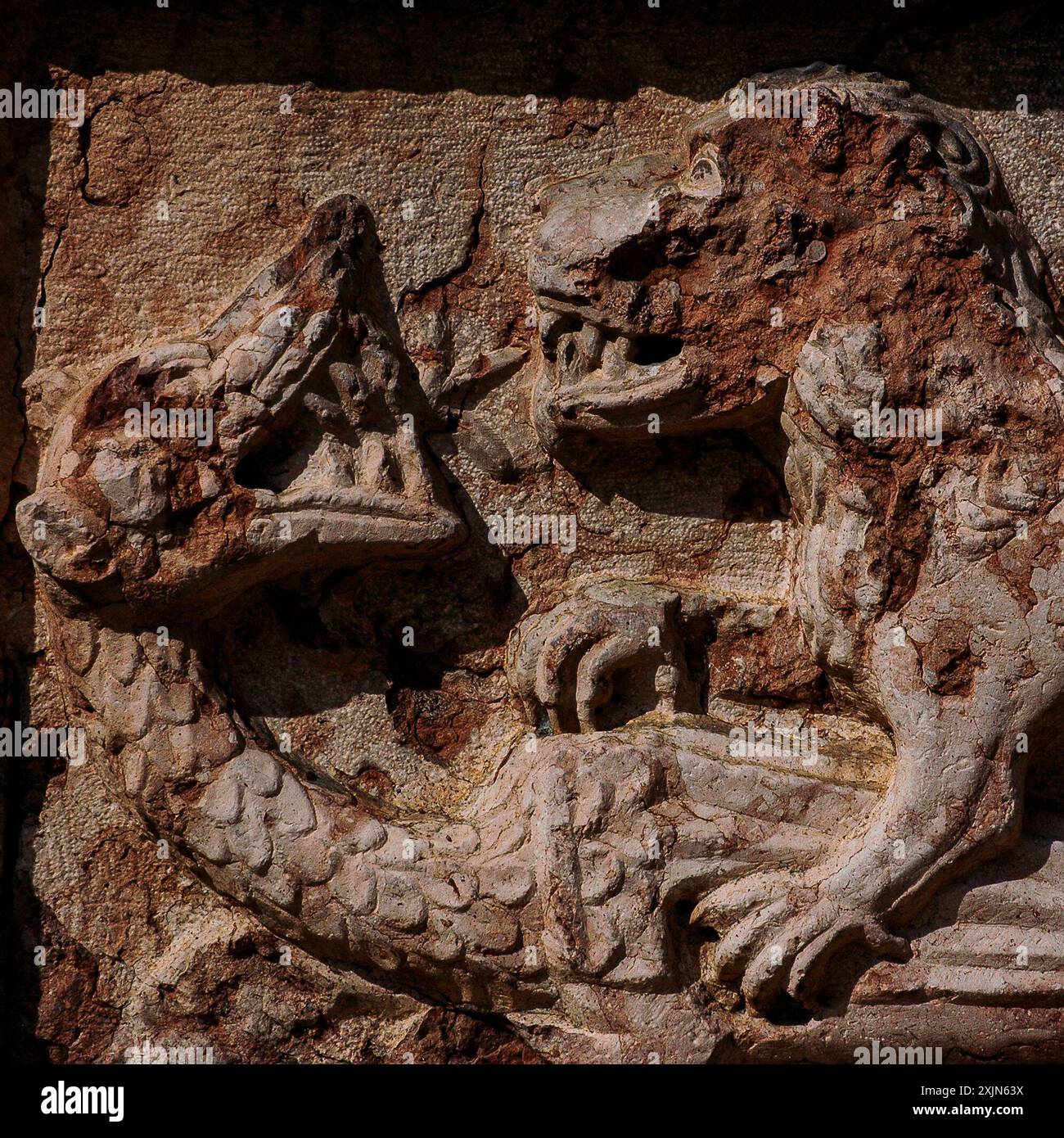 Scaly dragon, mouth open wide, and lion with teeth and claws bared ...