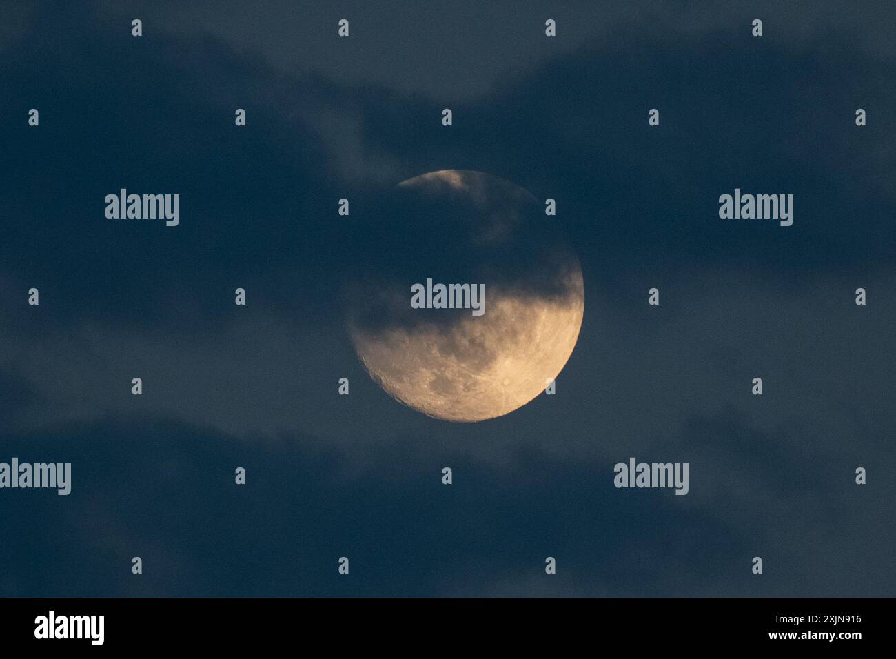 The moon rises while dark clouds loom in the sky in Srinagar, the ...