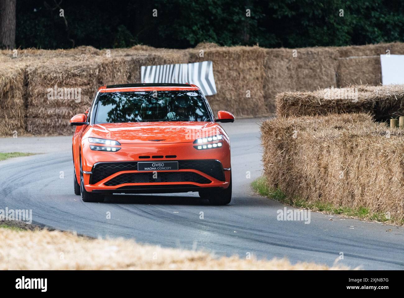 2024 Genesis GV60 Magma Concept car driving up the hill climb track at ...