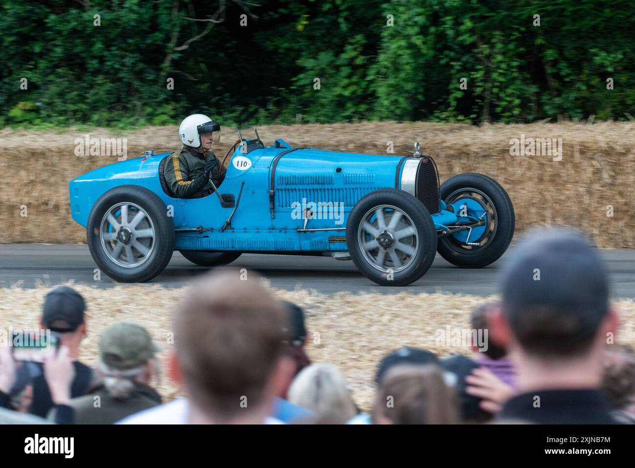 1927 Bugatti Type 35B race car driving up the hill climb track at the Goodwood Festival of Speed ...