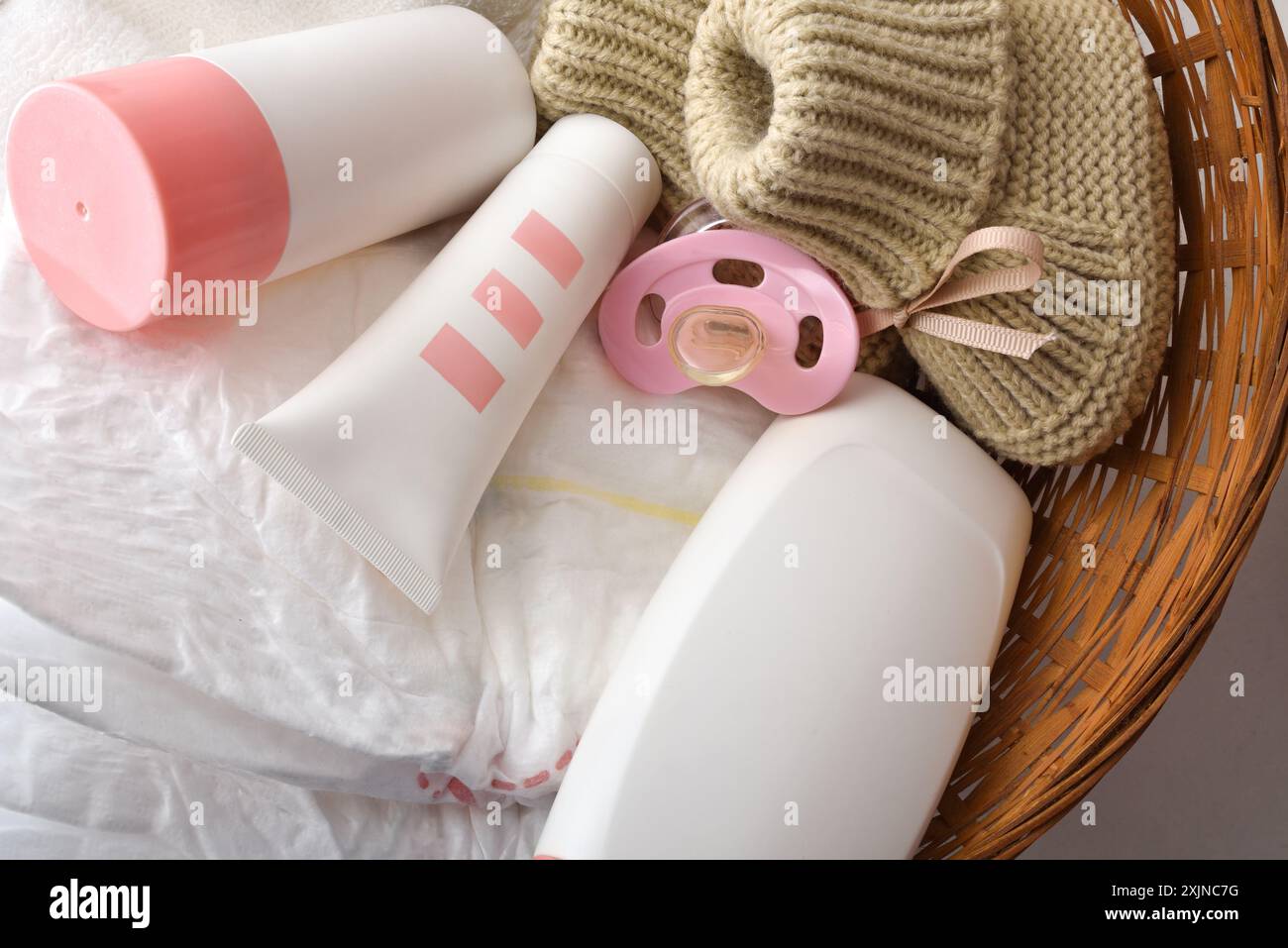 Basket with creams for changing the baby's diaper with pink tones. Top ...
