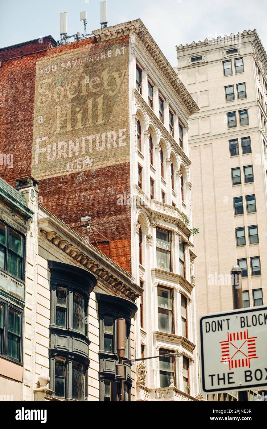 Historic brick building with an advertising mural reading Soiety Hill Furniture in downtown area ...