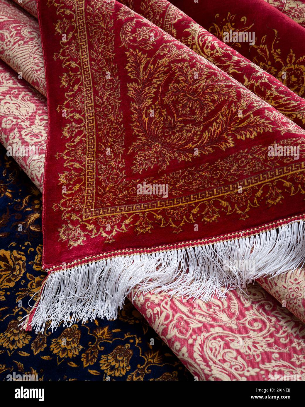 Exquisite red Persian carpet with intricate golden patterns and white ...
