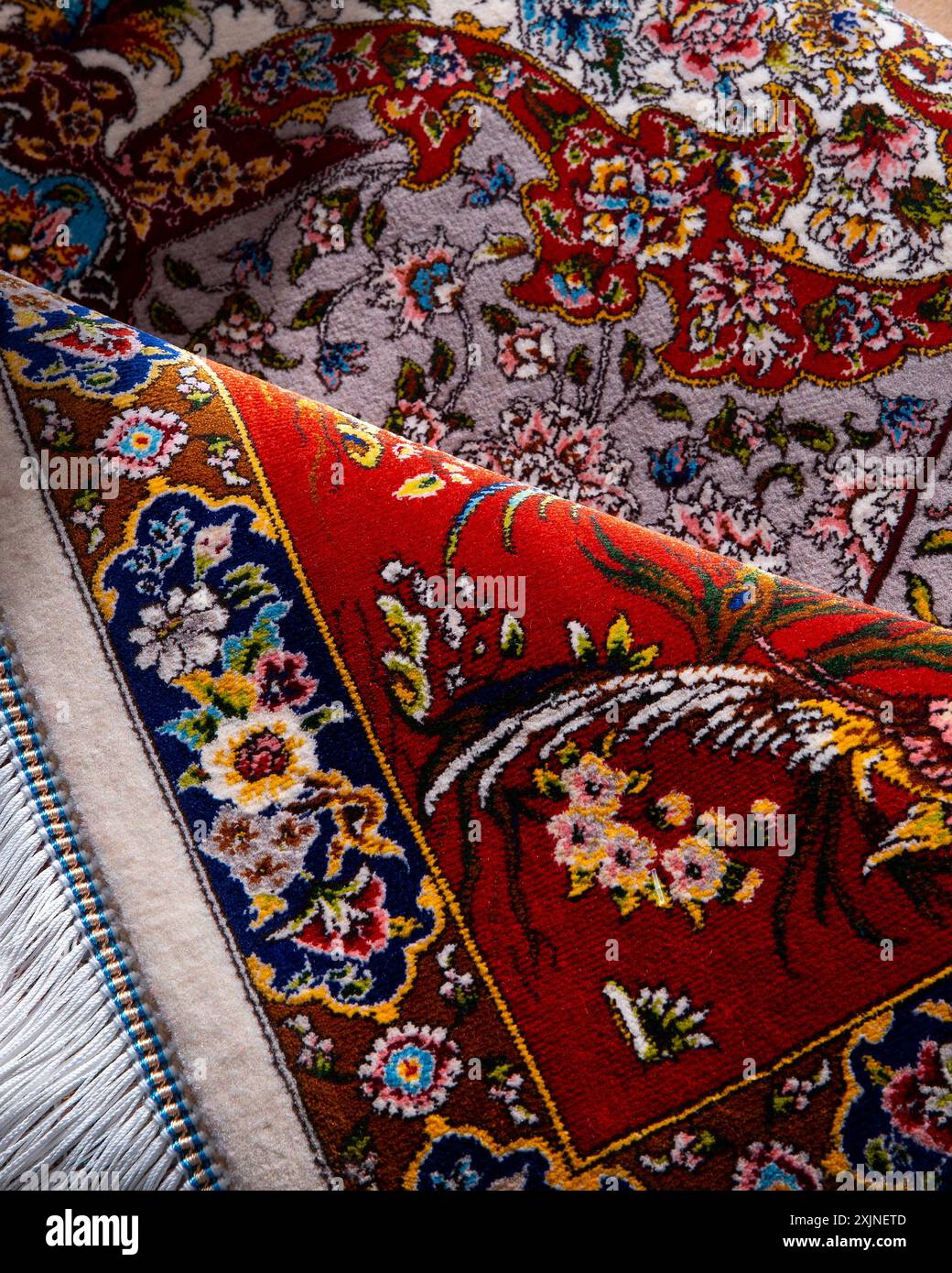 Luxurious Persian carpet with detailed floral patterns and a rich red ...