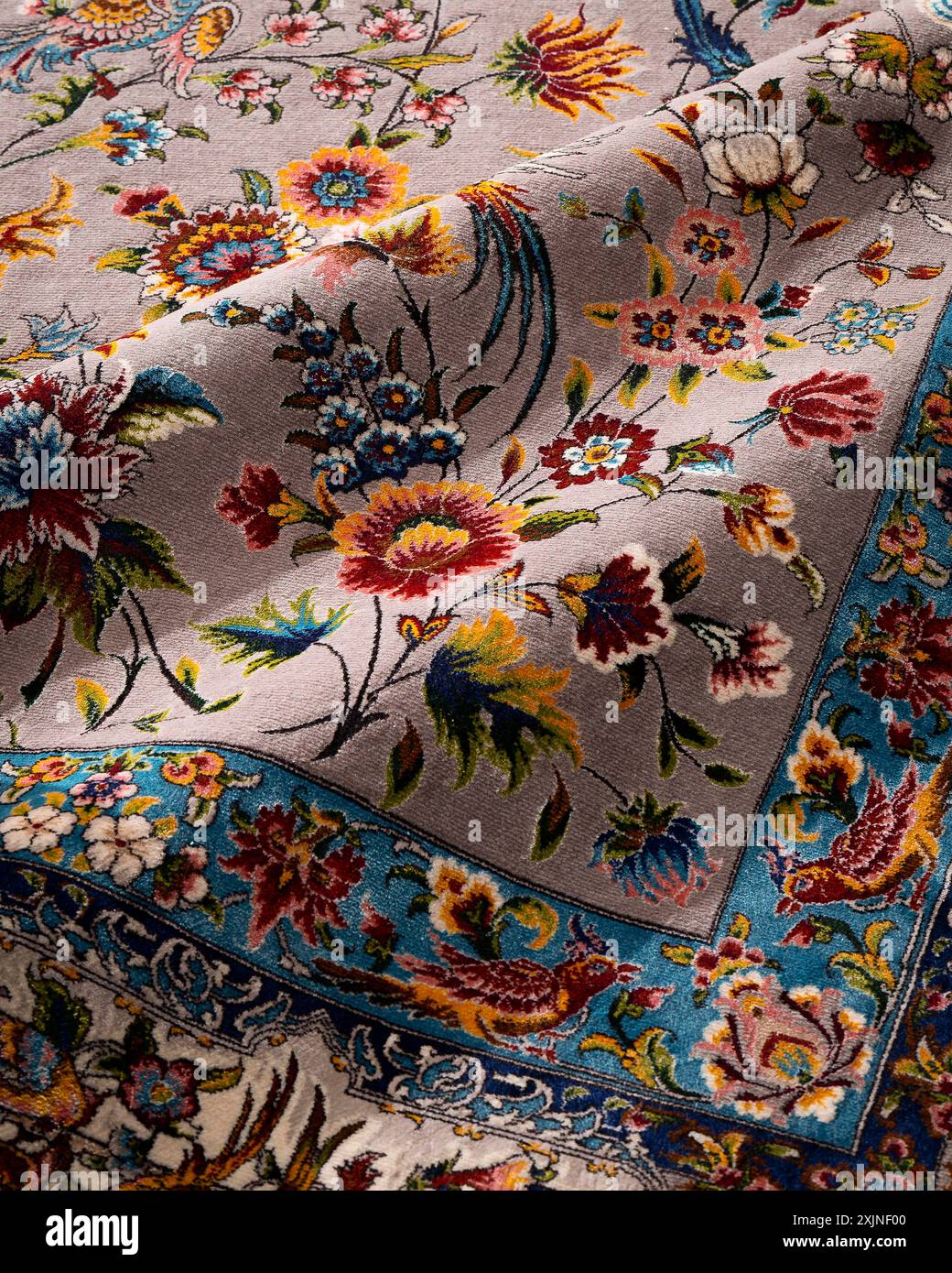 Beautiful Persian carpet with intricate floral designs and a soft grey ...
