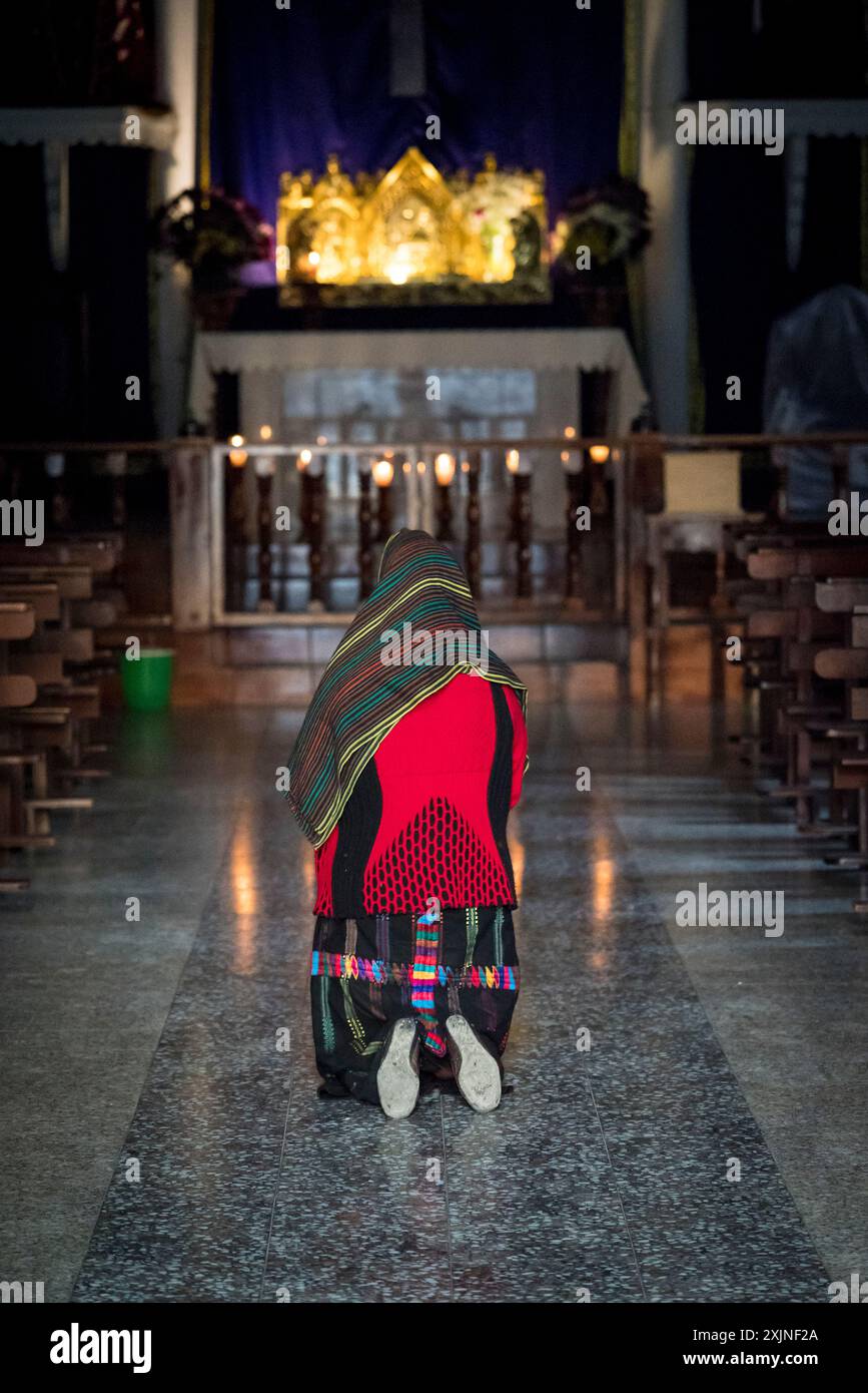 Mayan woman walking on her knees towards altar knees in the Catholic ...