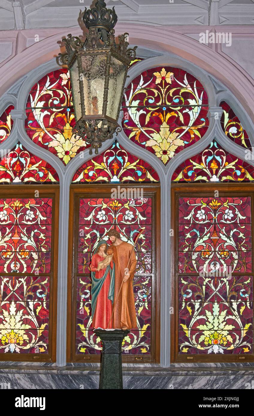 stained glass window, decorative wood framing, statue, Holy Family ...