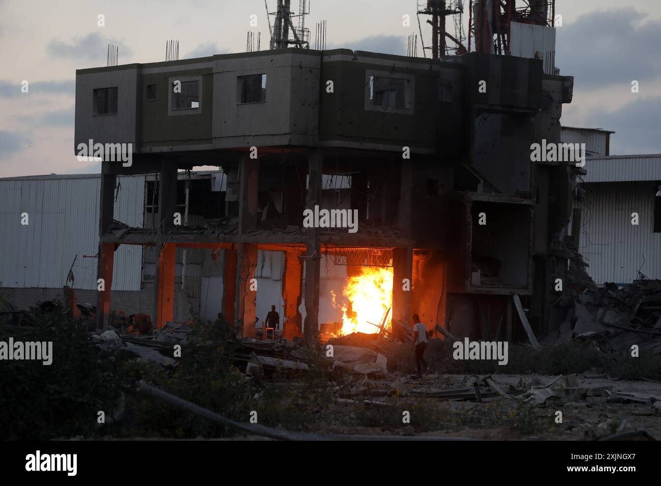 Palestinians inspect the area following an attack by the Israeli army ...