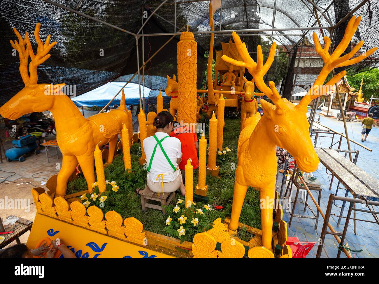 Thai Villagers decorate the candle procession for the Candle Parade to ...