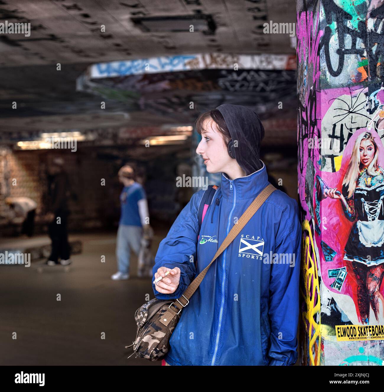 A young girl at a skatepark smoking a cigarette Stock Photo - Alamy