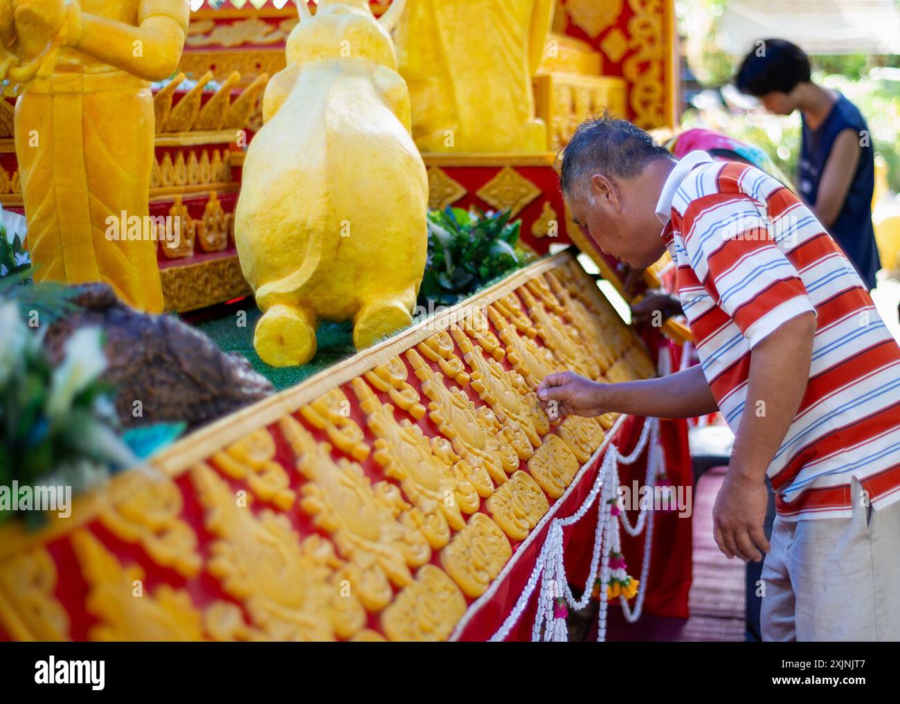 Thai Villagers decorate the candle procession for the Candle Parade to ...