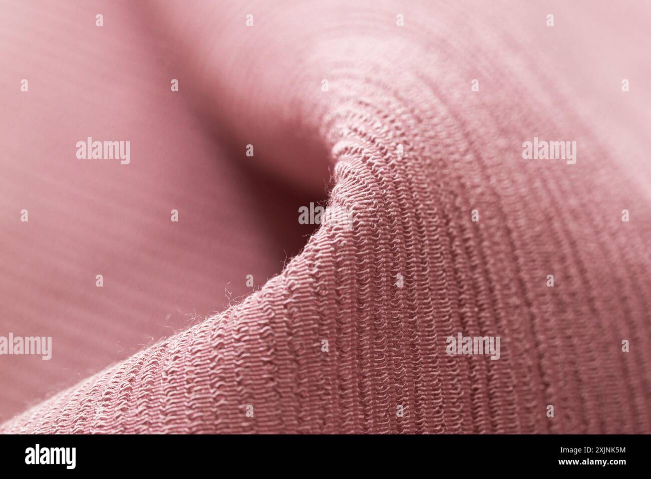 Close-up texture of soft pink fabric, ideal for backgrounds and textile ...
