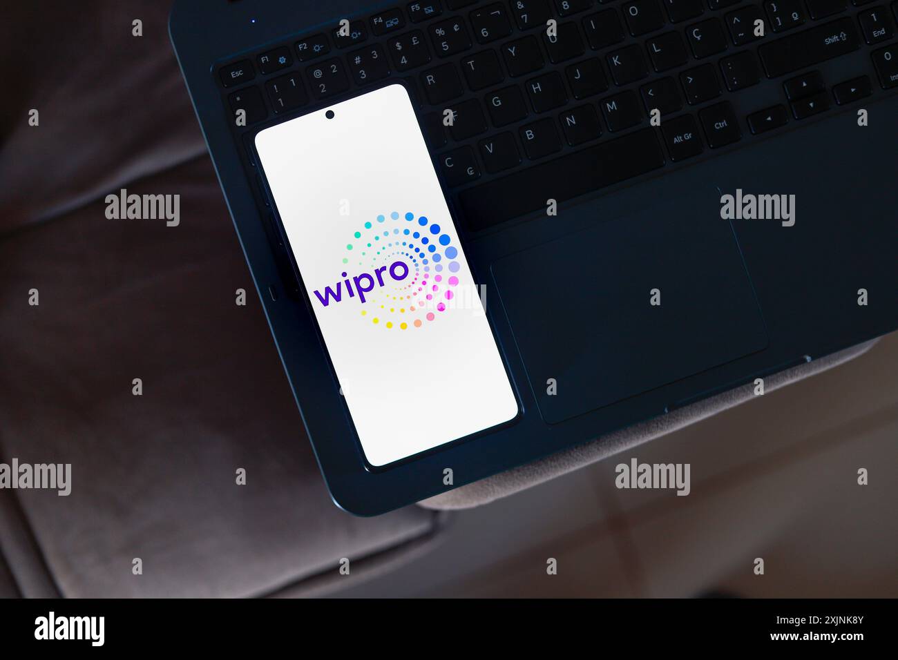 In this photo illustration, the Wipro Technologies logo is displayed on a smartphone screen ...