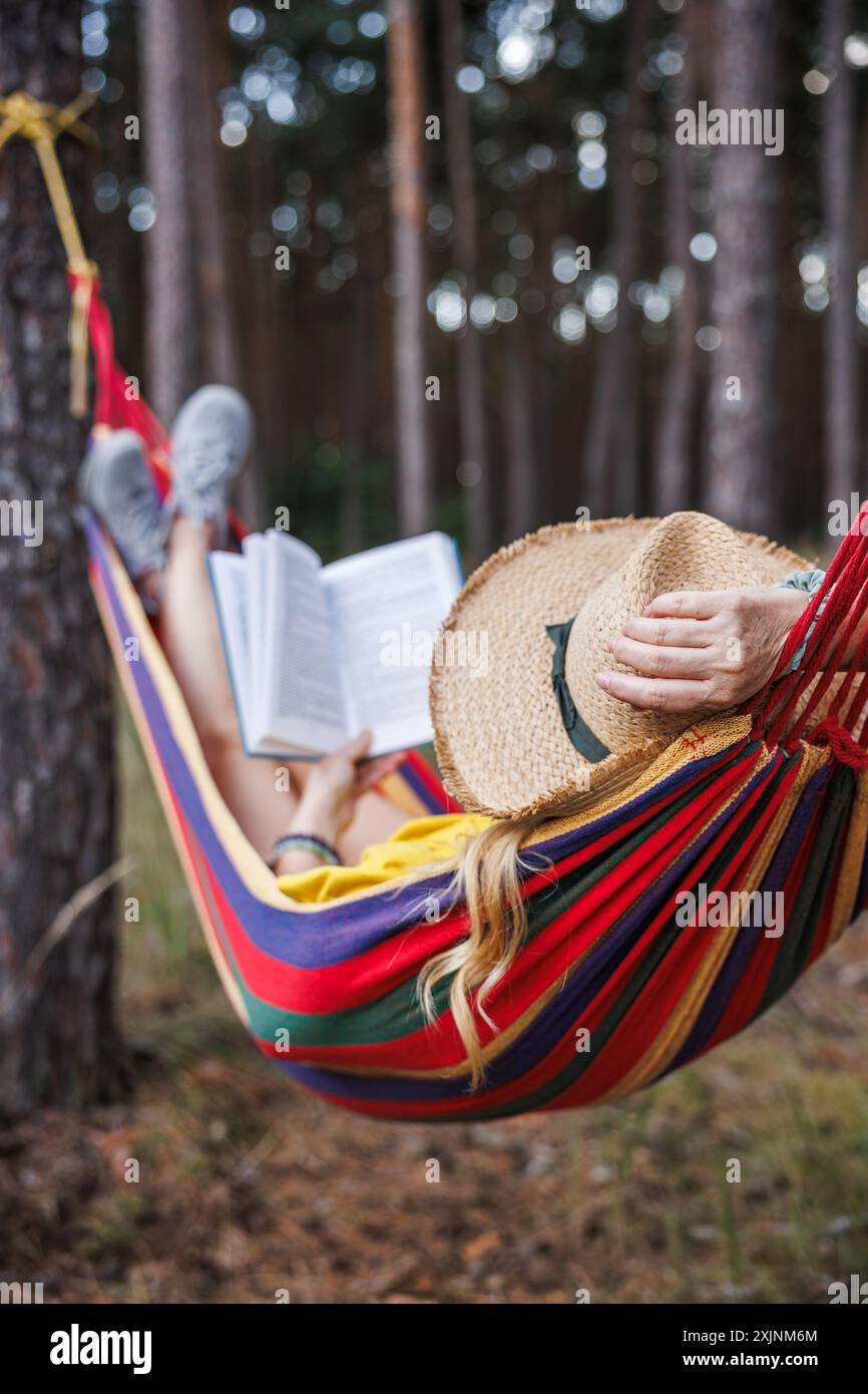 Relaxation with book outdoors. Woman resting and reading book in ...