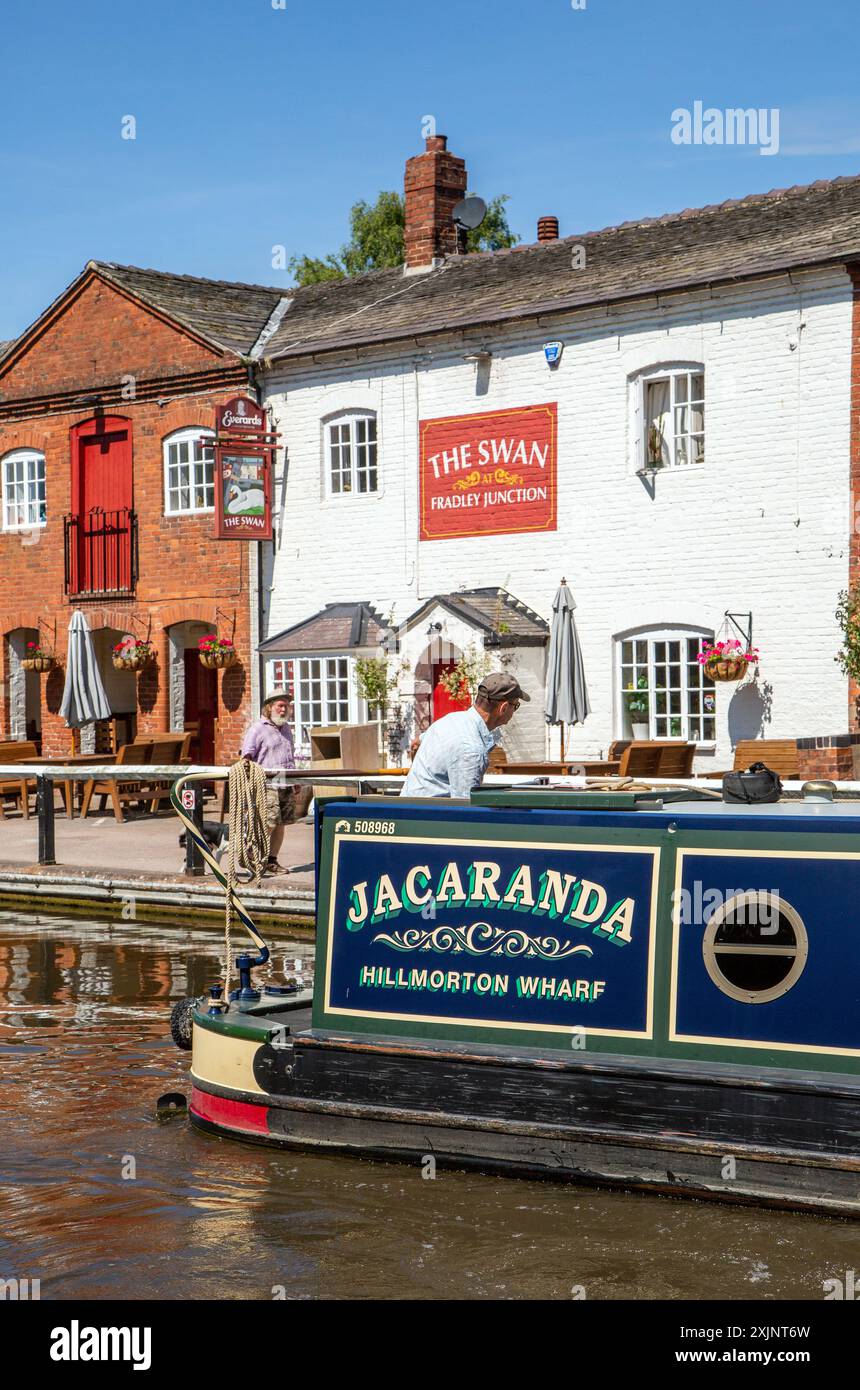 Canal narrowboat moored outside the Swan inn public house on the Trent ...