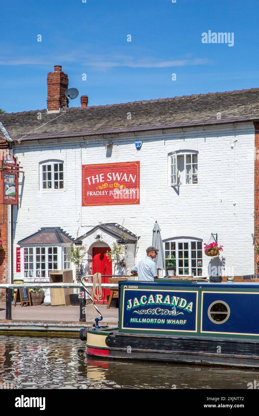 Canal narrowboat moored outside the Swan inn public house on the Trent ...