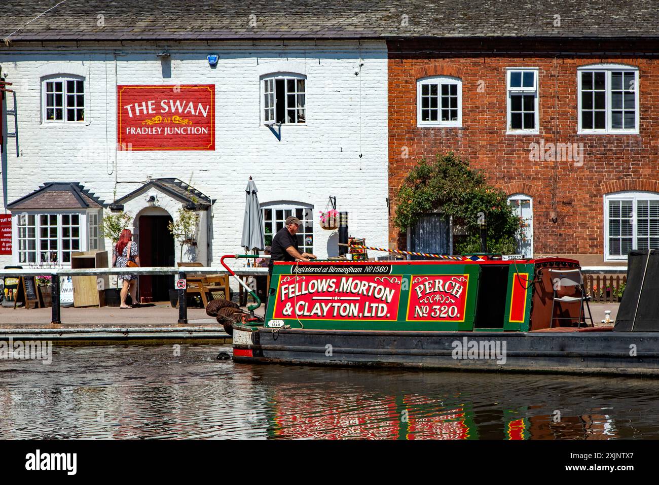 Former working canal narrowboat Perch, moored outside the Swan inn ...