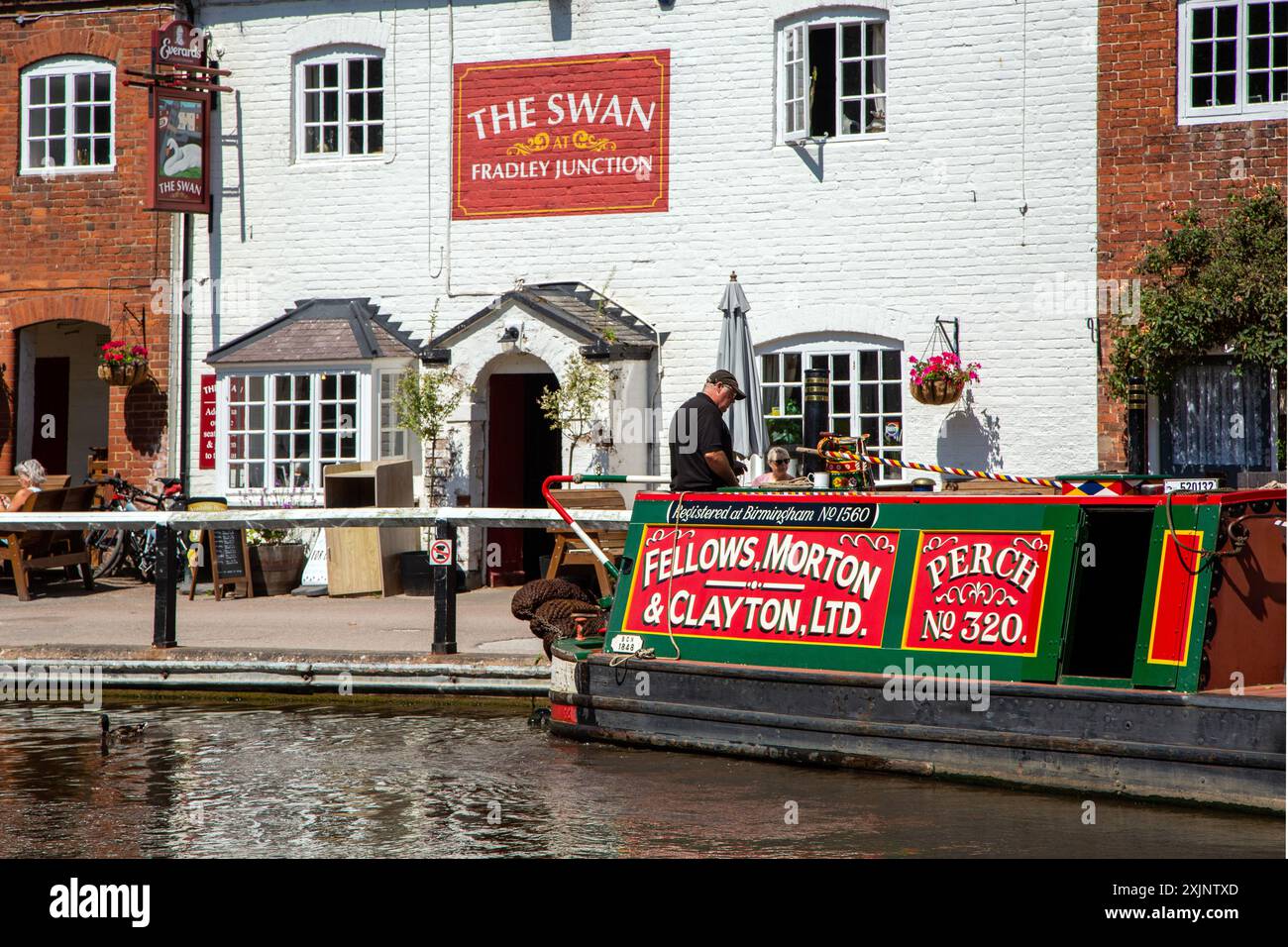 Former working canal narrowboat Perch, moored outside the Swan inn ...
