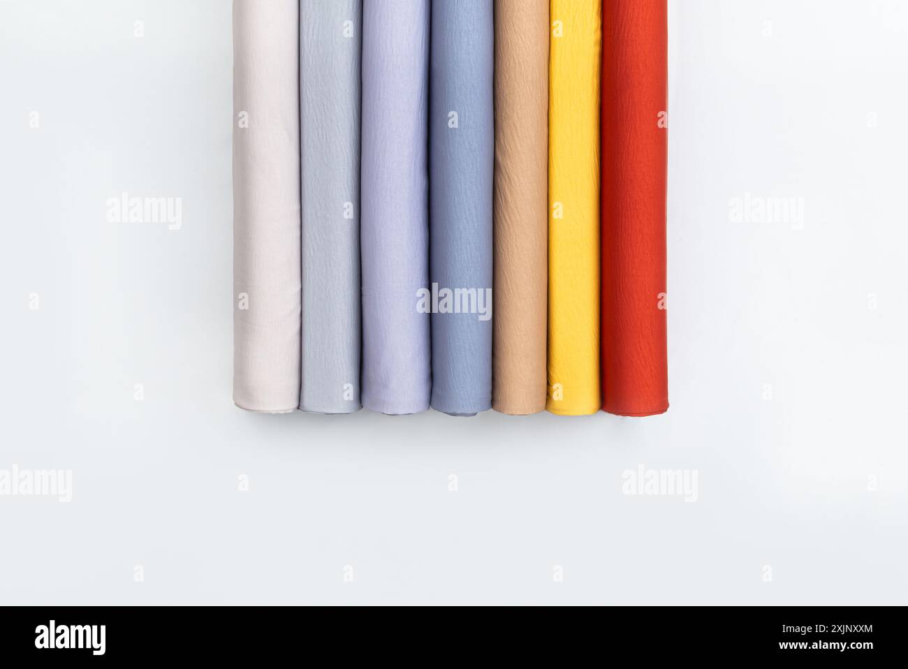 Roll of colorful fabrics hanging on a floor Stock Photo - Alamy