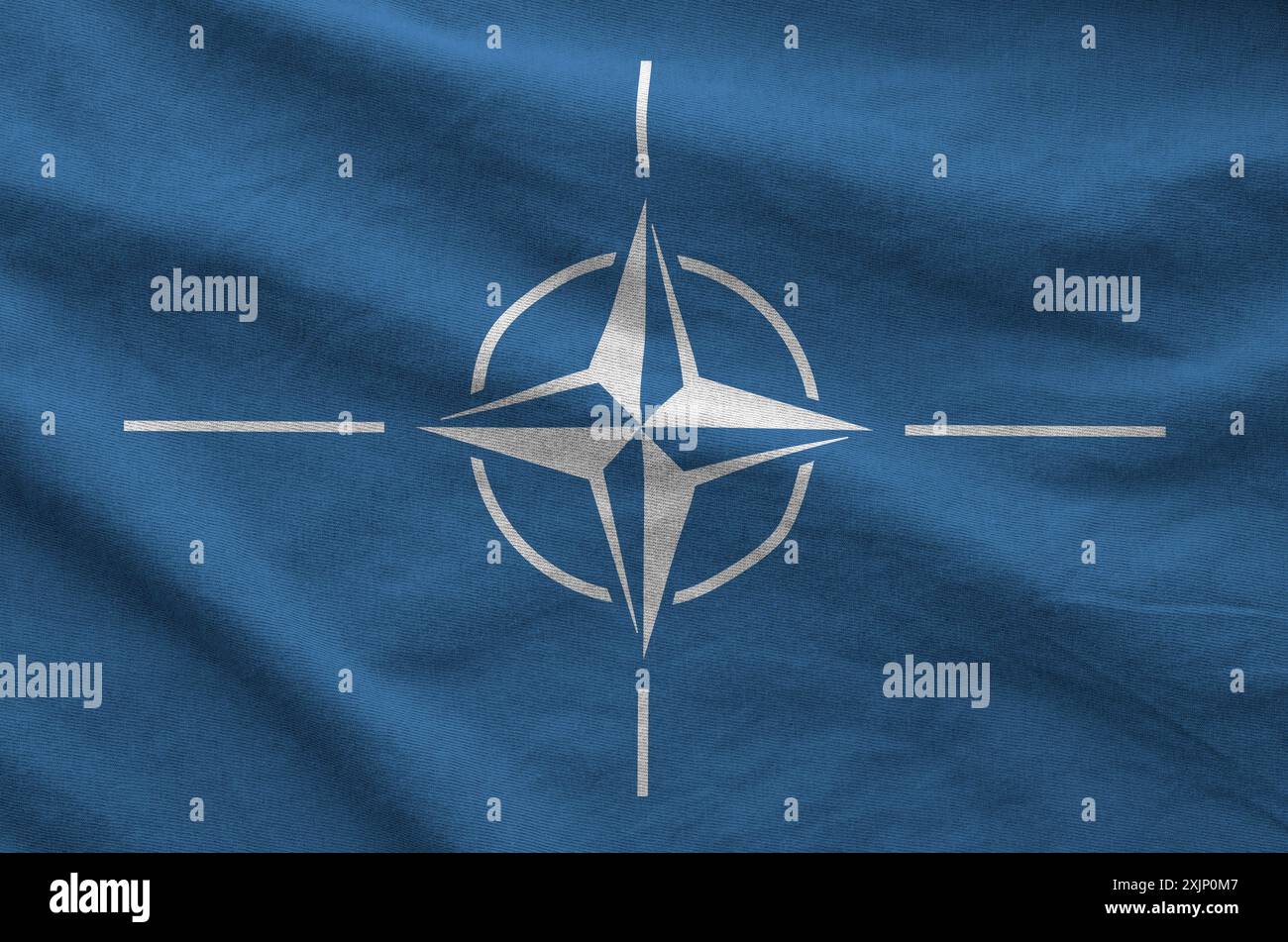 Nato flag depicted on folded wavy fabric of old cloth close up Stock ...