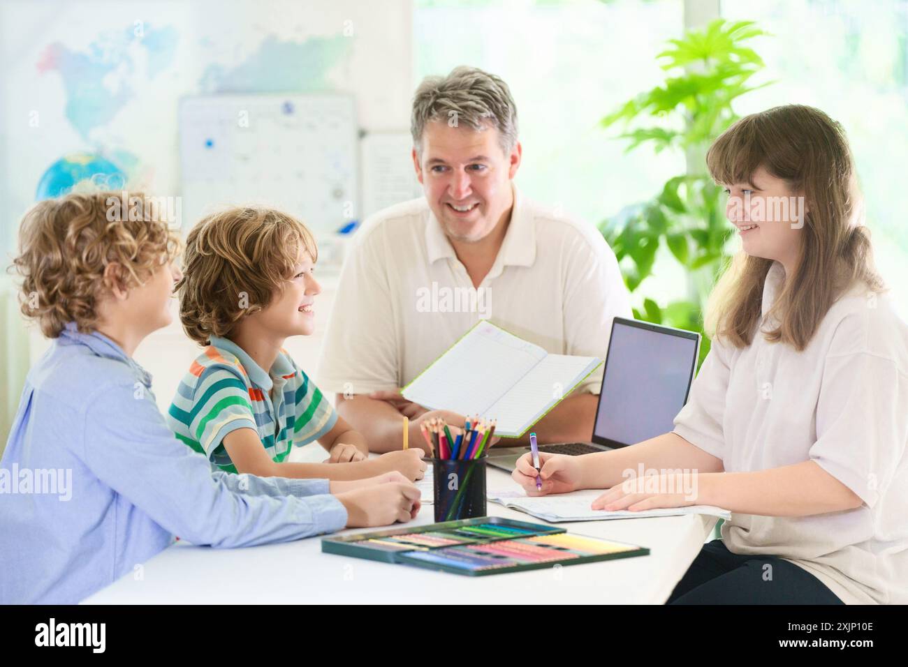Back to school. Kids and teacher in classroom during math class ...