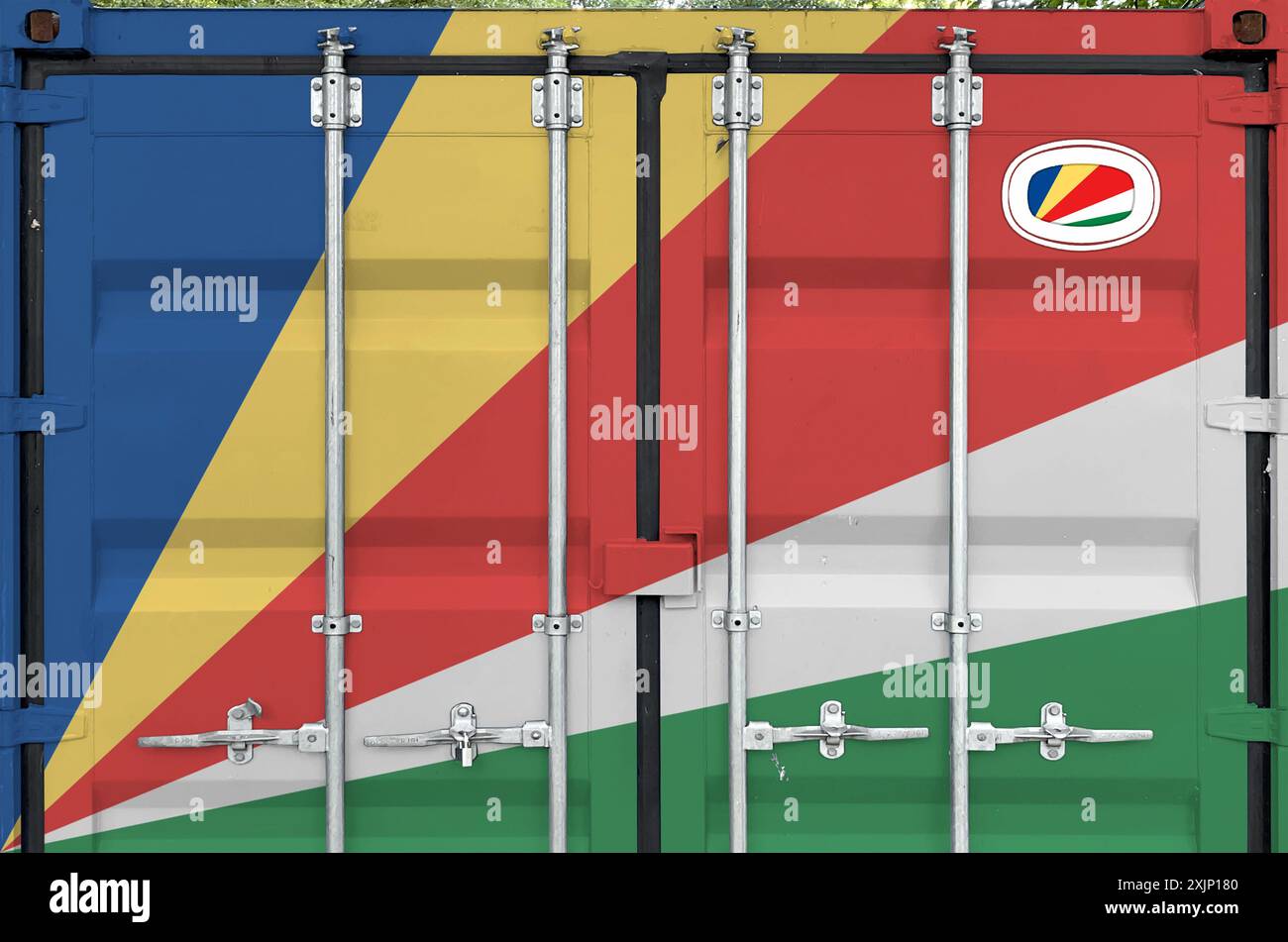 Seychelles flag depicted on metal doors of shipping cargo container outdoors in docks area close ...