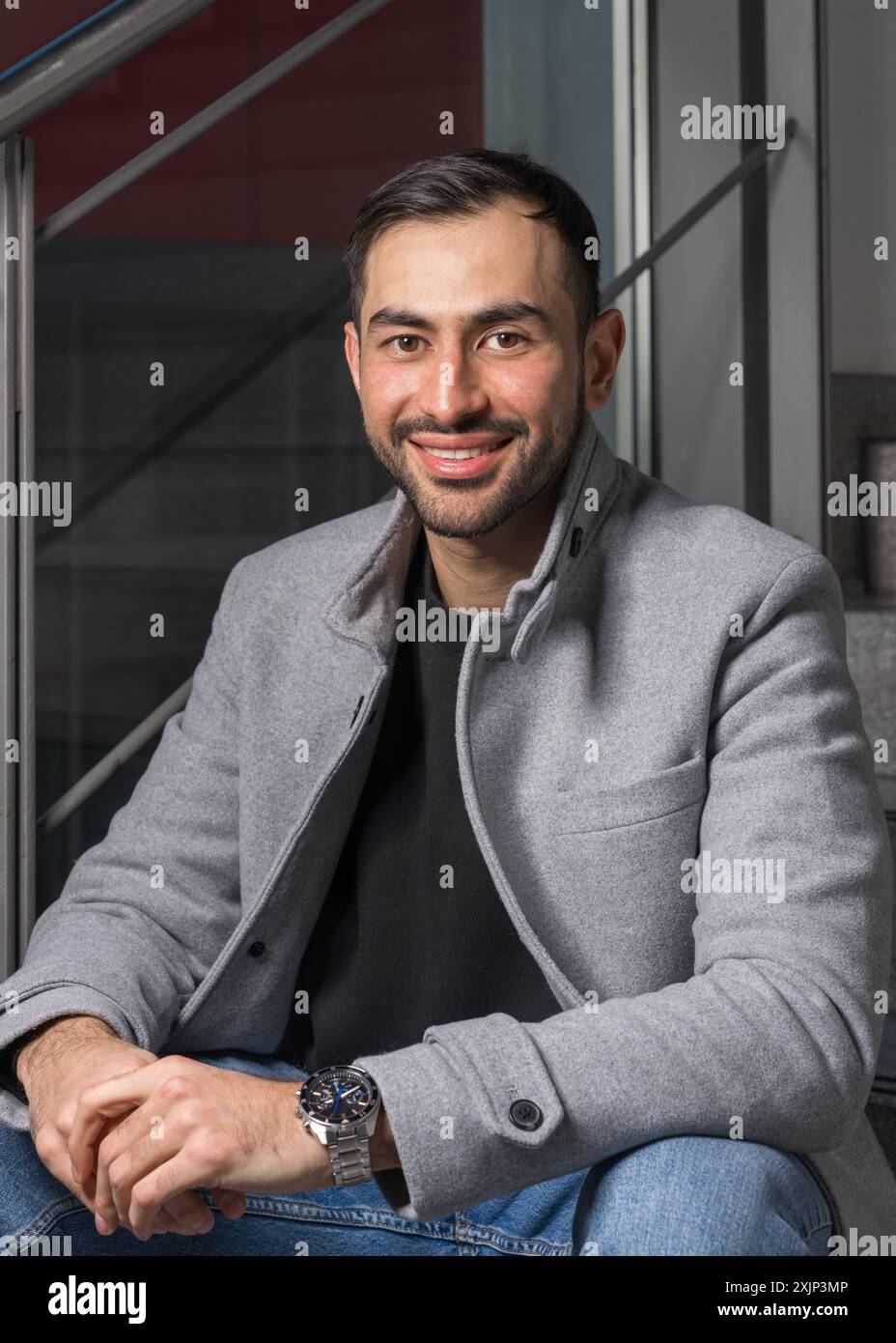 Positive young worker stands hi-res stock photography and images - Alamy