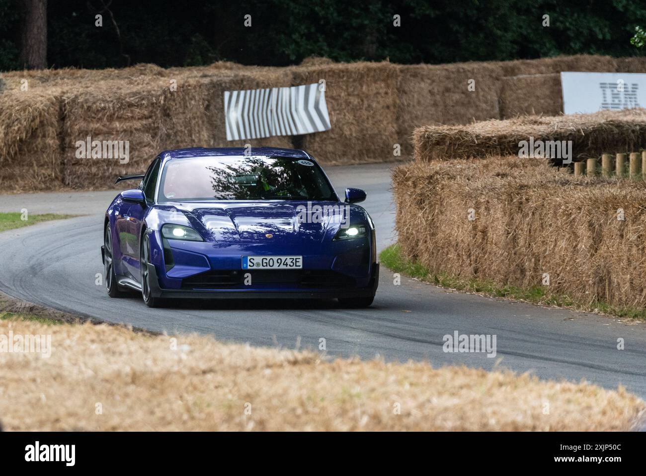2024 Porsche Taycan Turbo GT electric car driving up the hill climb track at the Goodwood ...