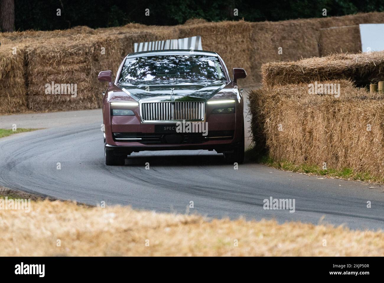 2024 Rolls-Royce Spectre luxury car driving up the hill climb track at ...