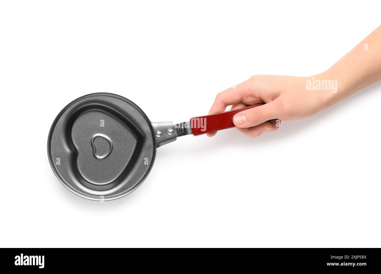 Female hand holding frying pan in shape of heart on white background ...