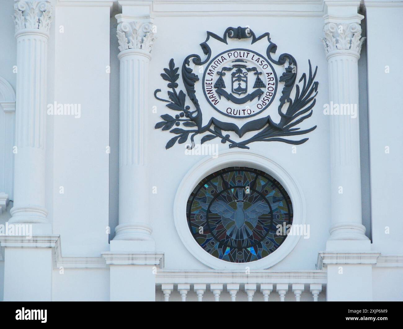Crest and circular stained glass window on the catholic church in ...