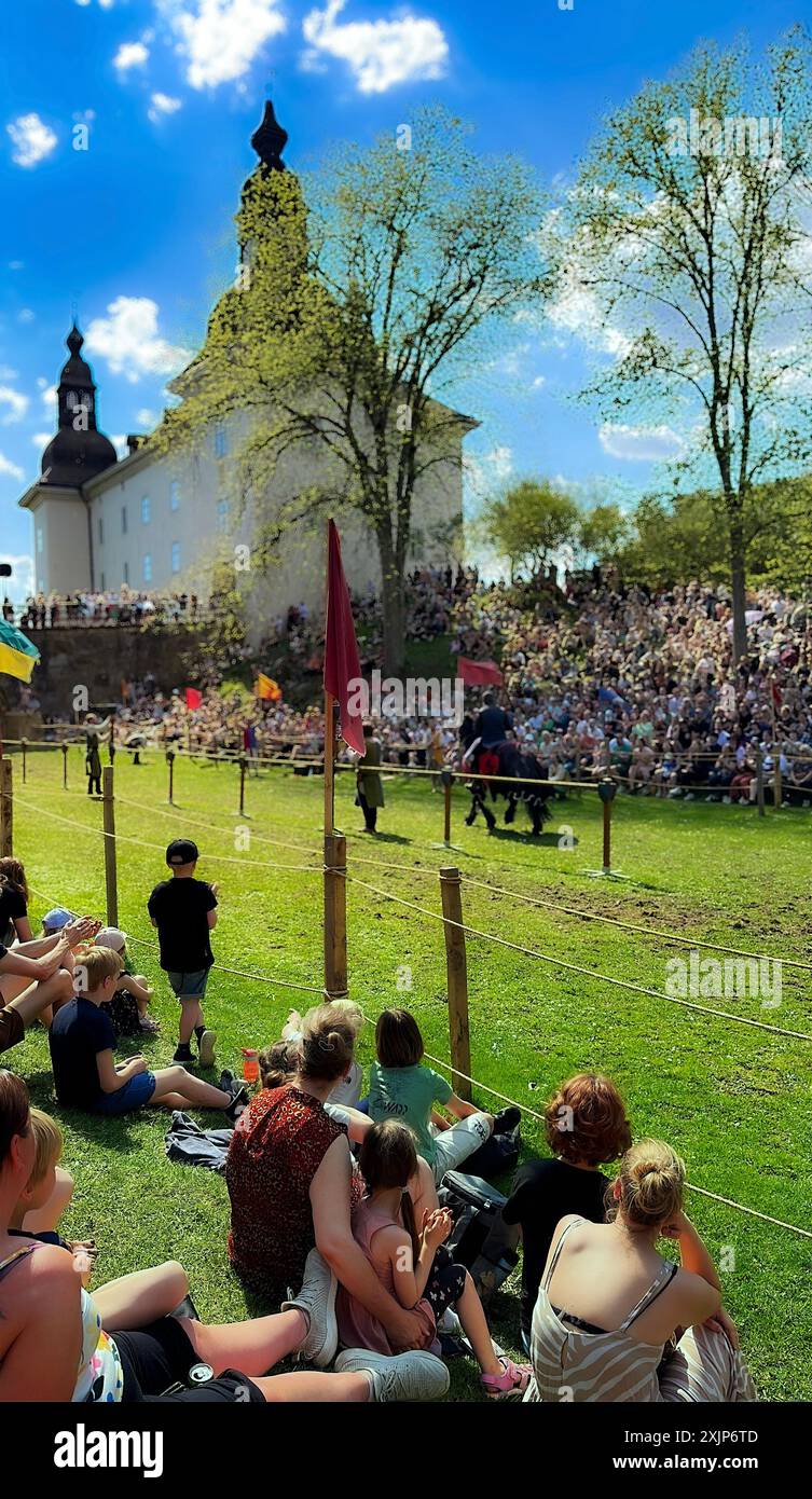 Medieval Festival with spectators near a historic church, cultural ...