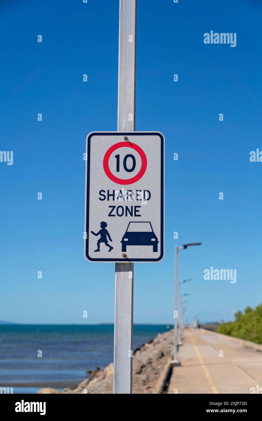 Sign notice of a shared zone with a speed limit Stock Photo - Alamy