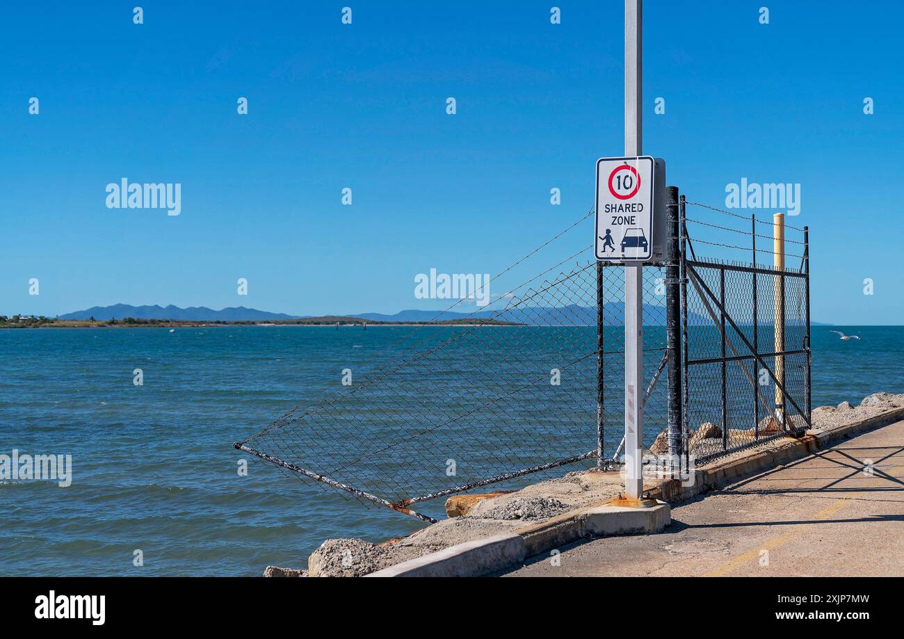 Details of a warning sign attached to a pole on a pier Stock Photo - Alamy