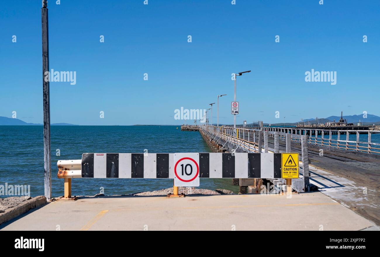 Details of a warning sign attached to a pole on a pier Stock Photo - Alamy