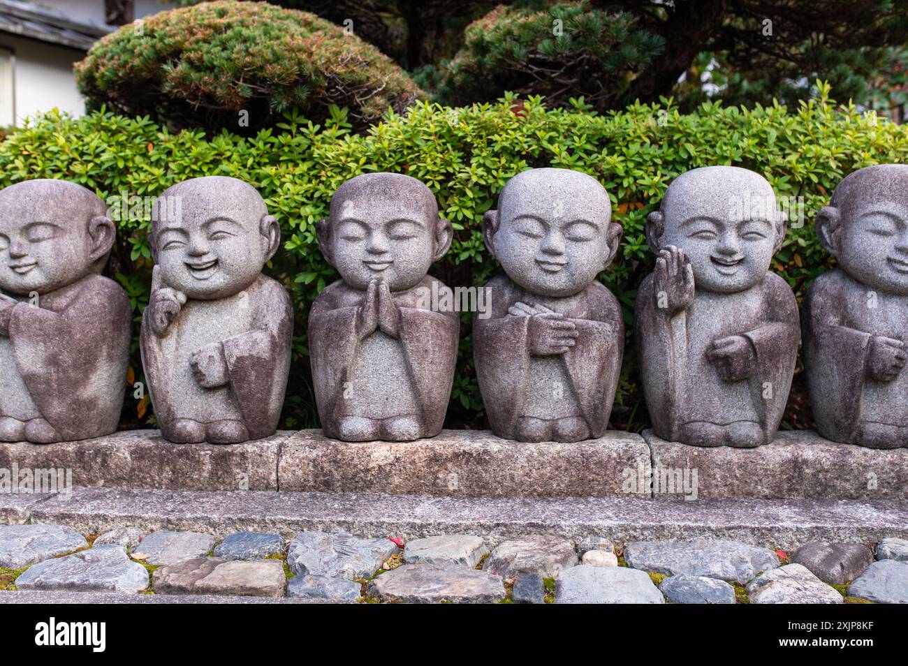 A charming row of Jizo statues, each with unique expressions and ...