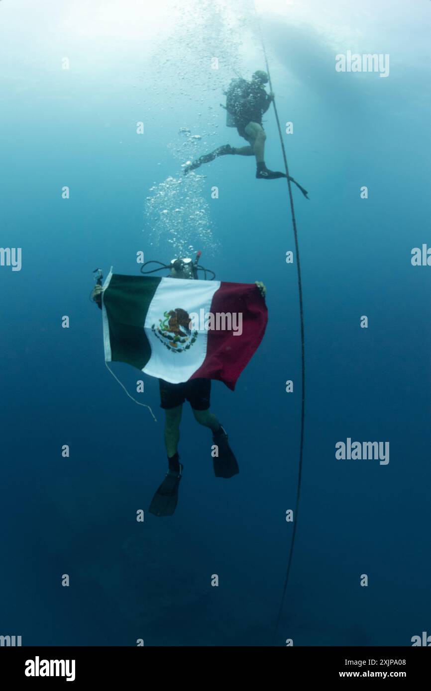 A Mexican diver displays his county flag during a familiarization dive ...