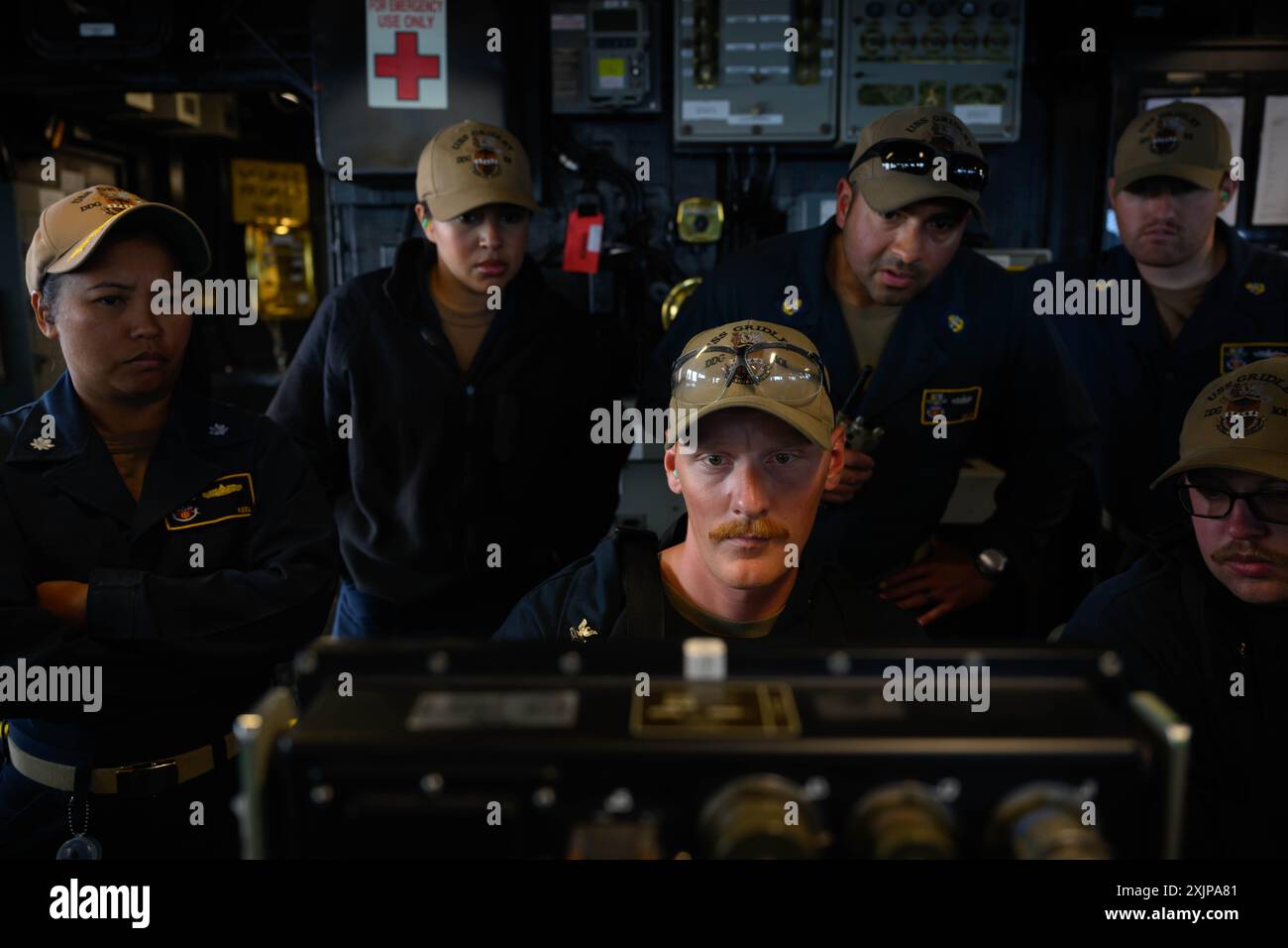 Sailors observe as Gunner’s Mate 2nd Class Wyatt Morrissey fires an MK ...