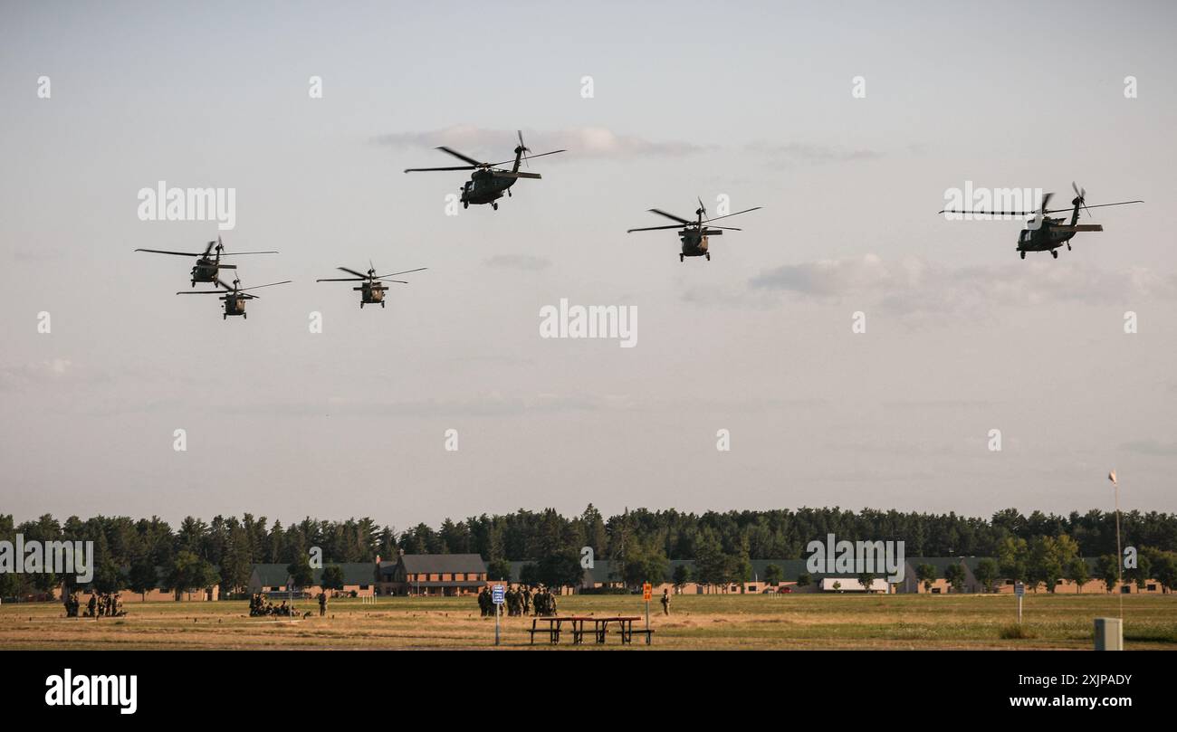UH-60 Black Hawk helicopters fly in formation as they prepare to land ...