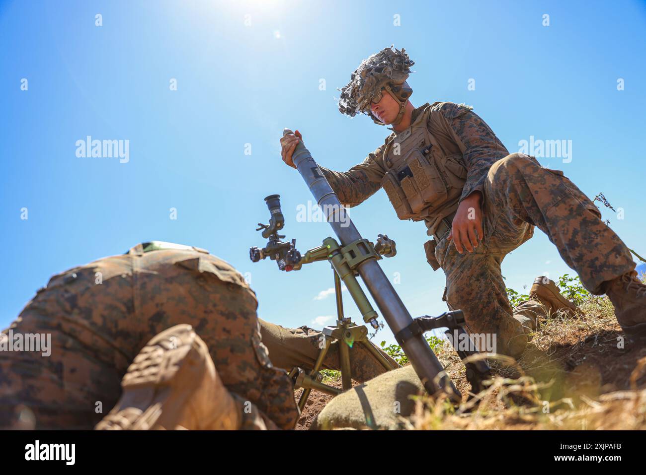 U.S. Marine Corps Lance Cpl. Brice Enter, right, a mortarman assigned ...